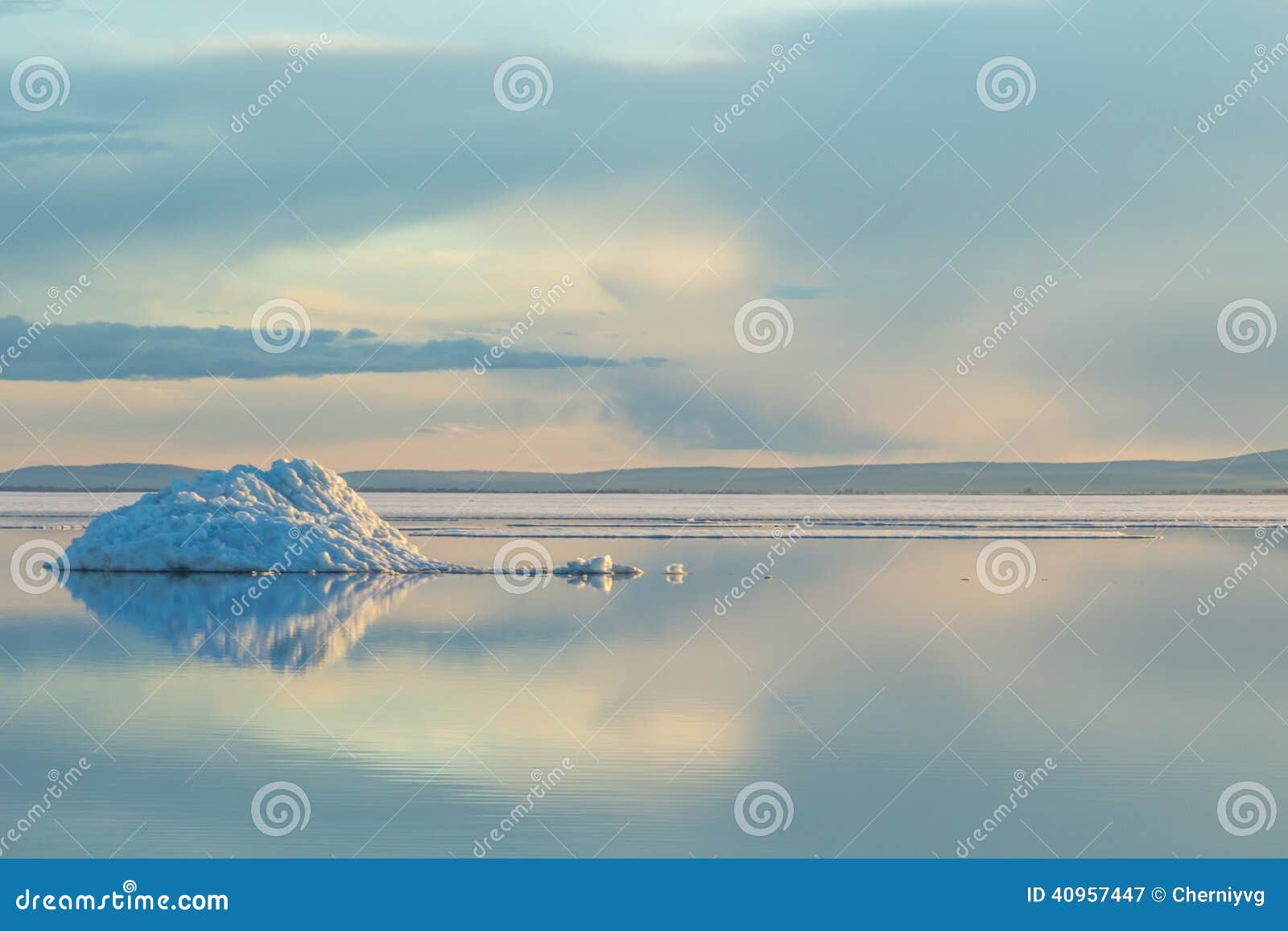 The Melting Iceberg on Spring Mountain Lake in the Setting Sun. Stock ...
