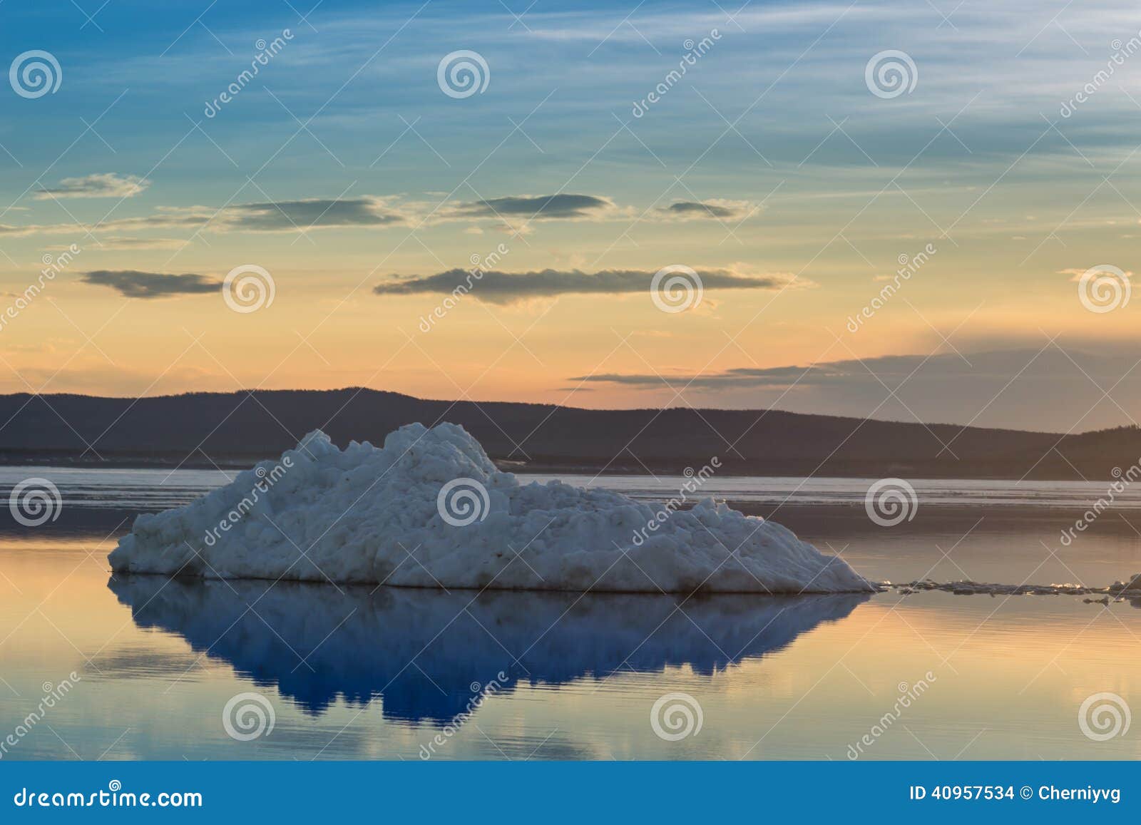 The Melting Iceberg on Spring Mountain Lake in the Setting Sun. Stock ...