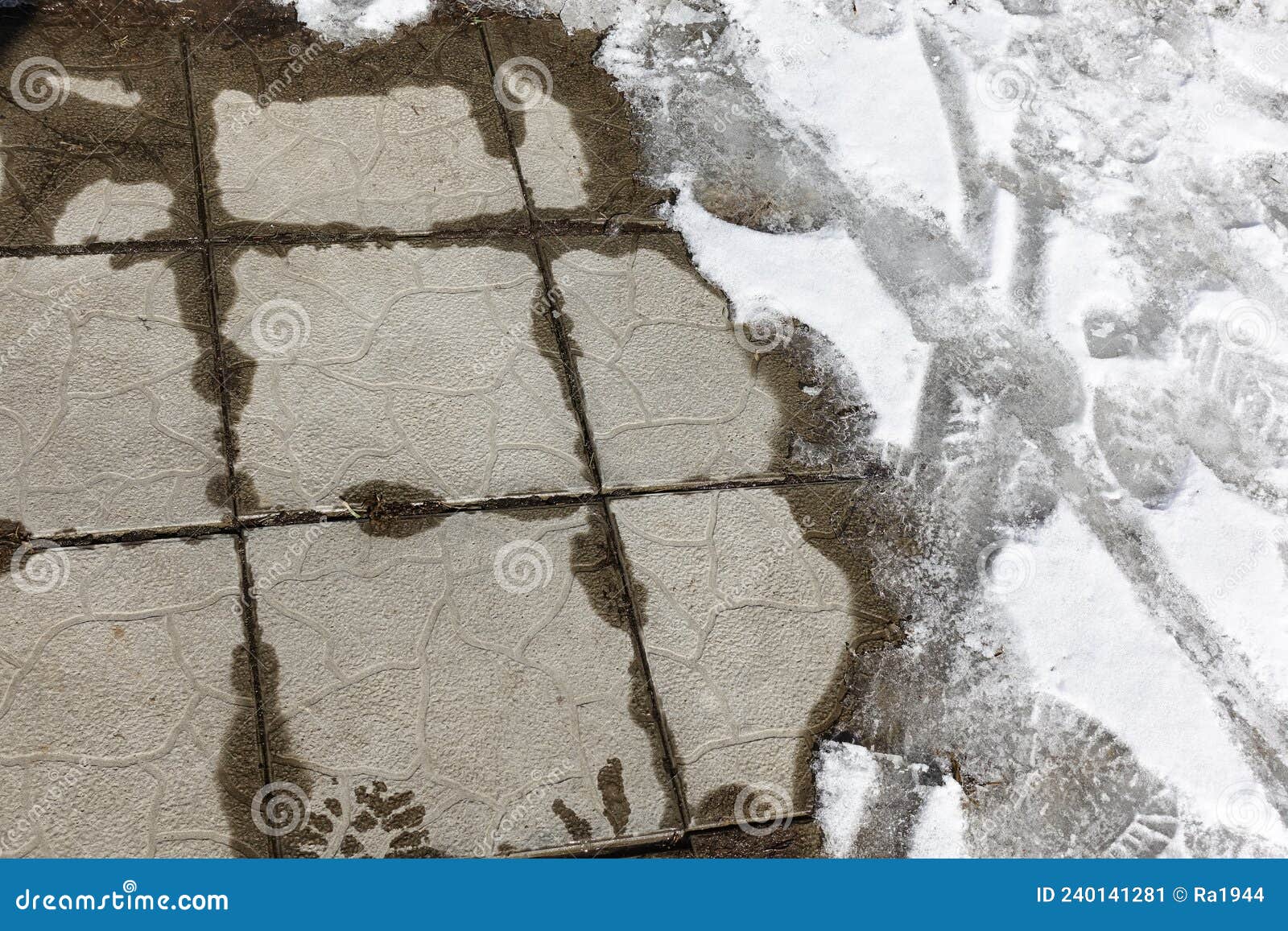 Melting Snow on the Paving Slabs during Spring Thaw. Patch of Sidewalk ...