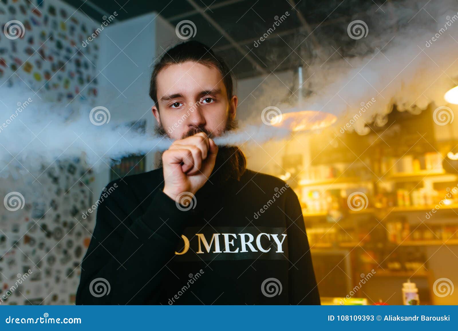 Young Men with Beard Vaping and Releases a Cloud of Vapor. Close-up ...