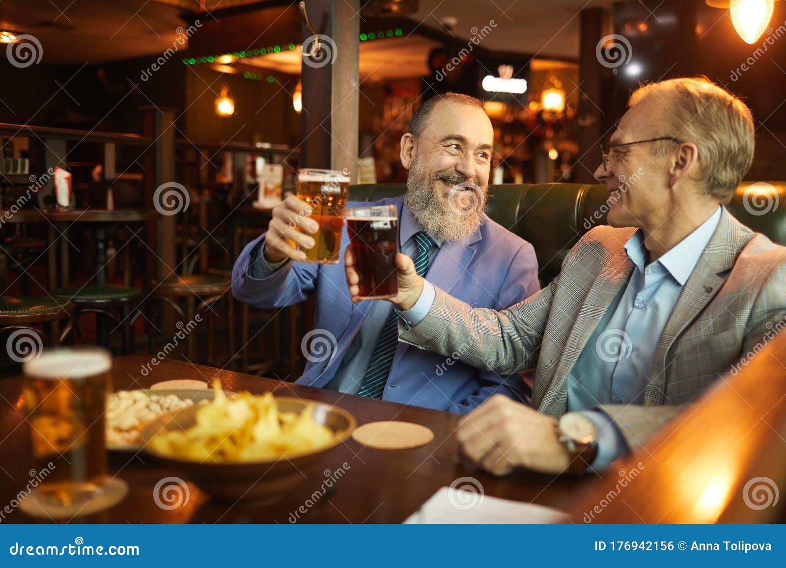 Men celebrating in the bar stock photo. Image of restaurant - 176942156