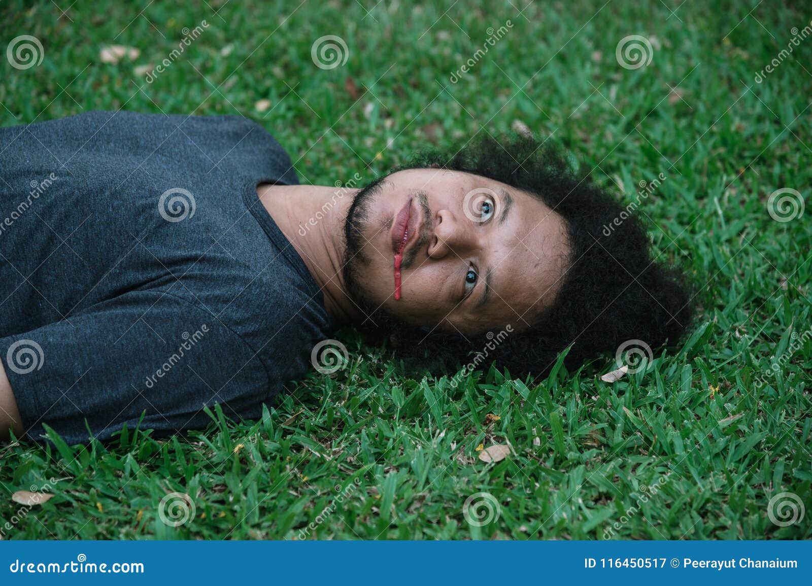 Men Dead on the Grass and Bleed from the Mouth. Stock Image - Image of ...