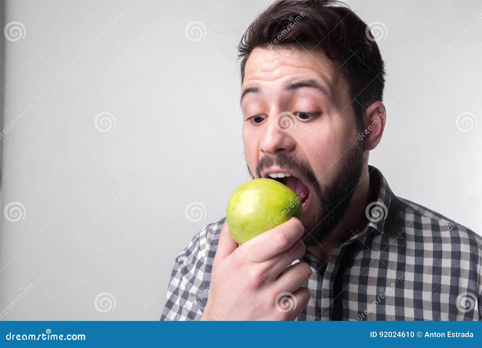 Men Eats an Apple. Bearded Guy Holding an Apple Stock Photo - Image of ...