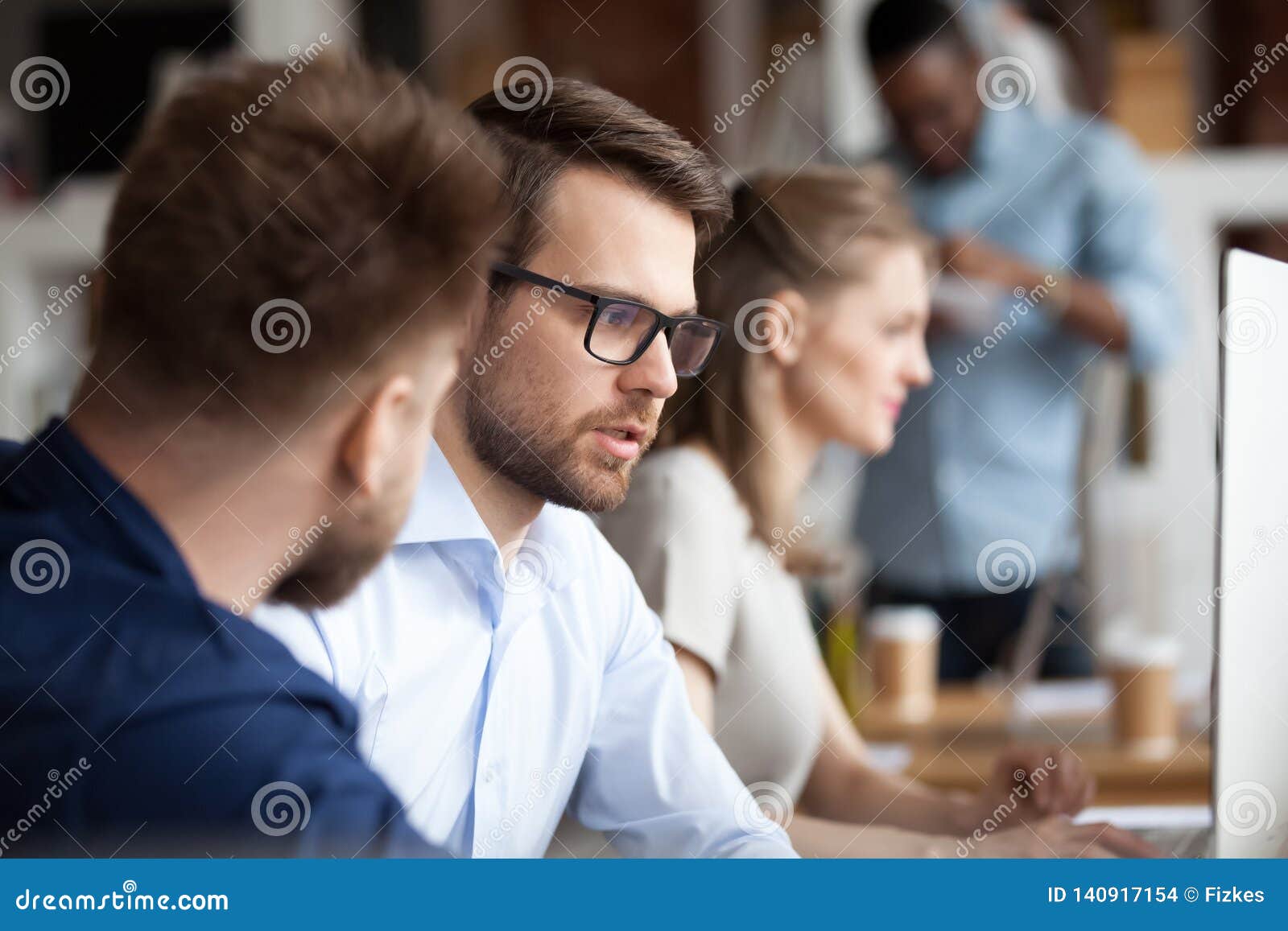 Men Employees Working Together at Shared Workspace Stock Photo - Image ...