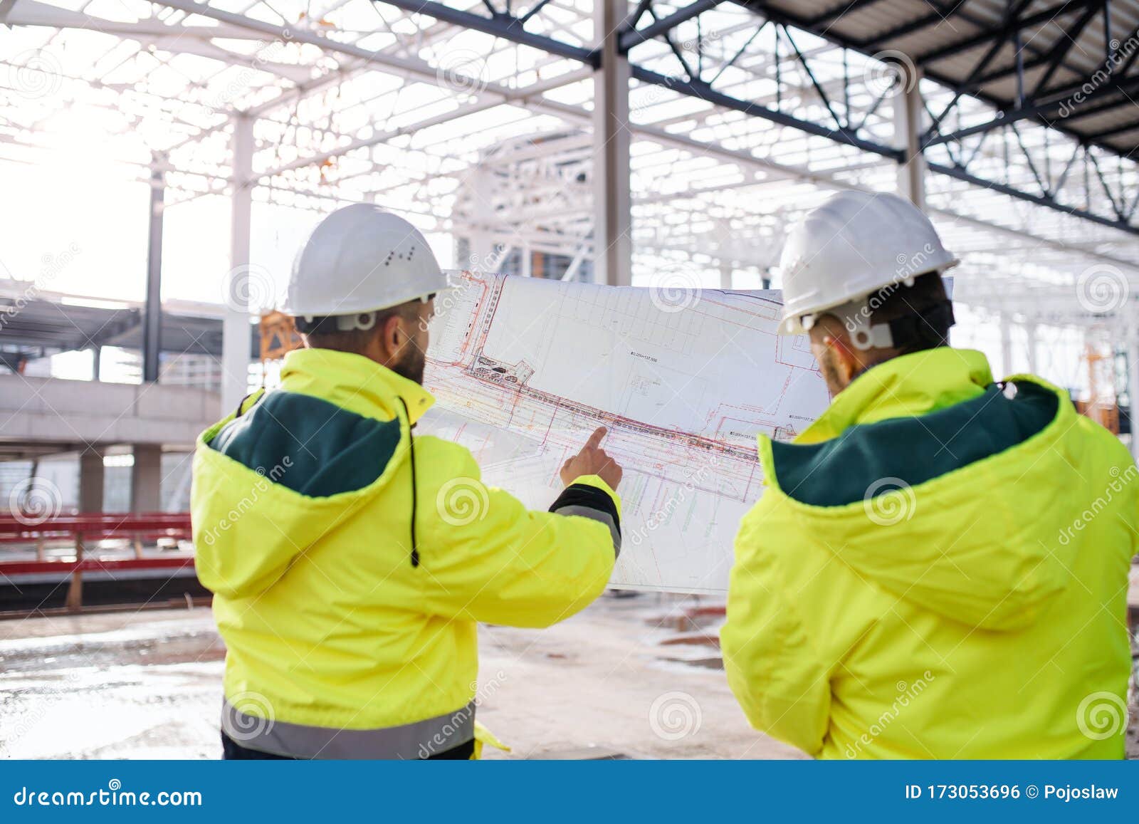 Men Engineers Standing Outdoors on Construction Site, Holding ...