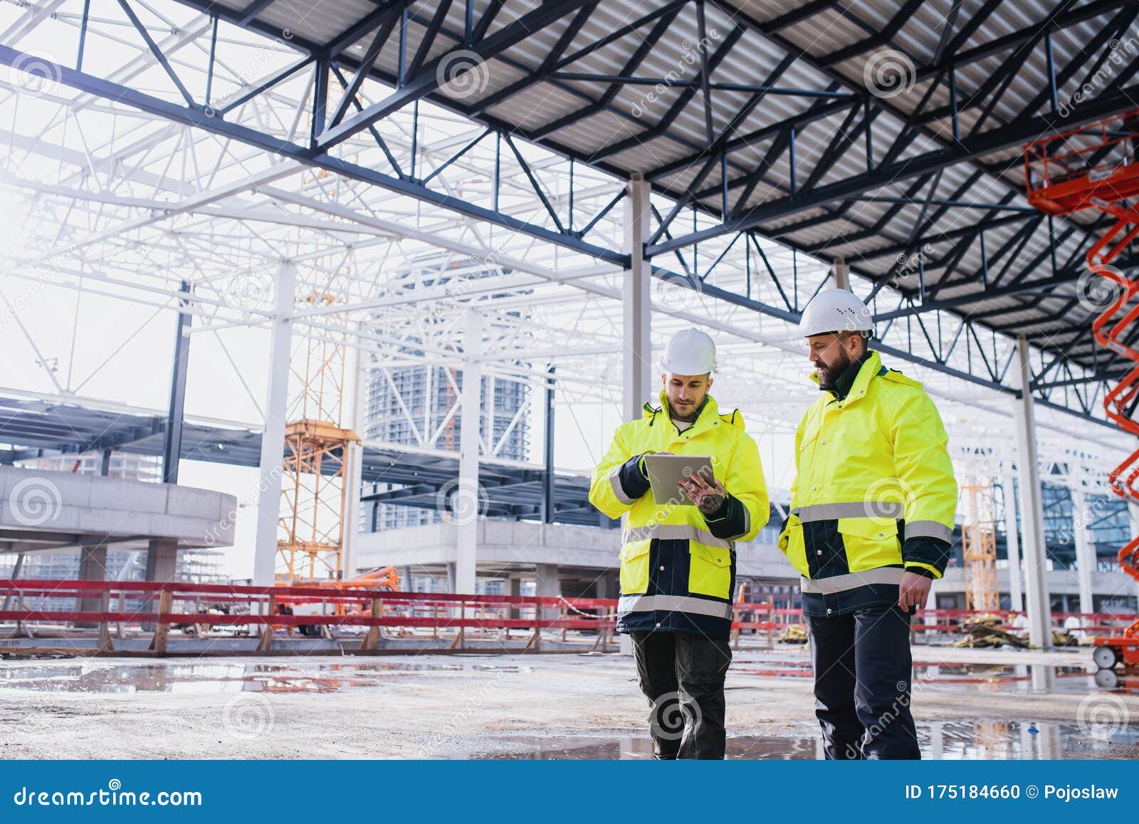Men Engineers Standing Outdoors on Construction Site, Using Tablet ...