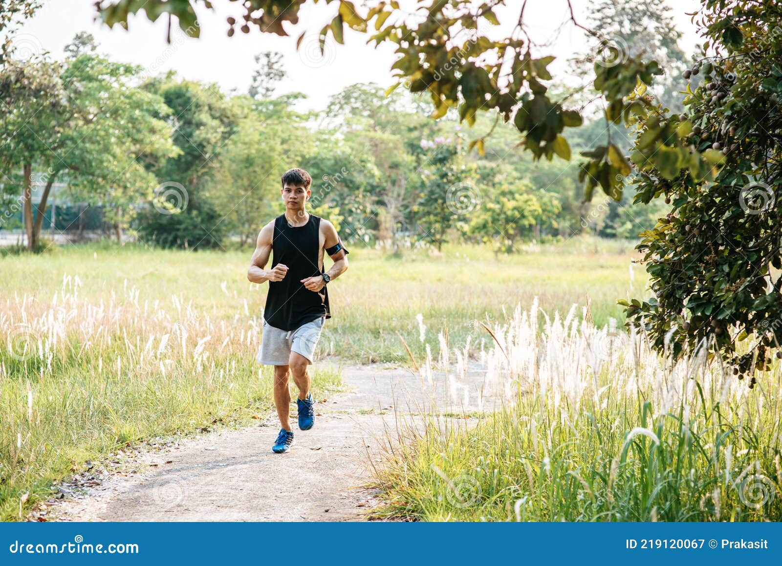Men Exercise by Running on the Streets with Trees and Flowers Stock ...