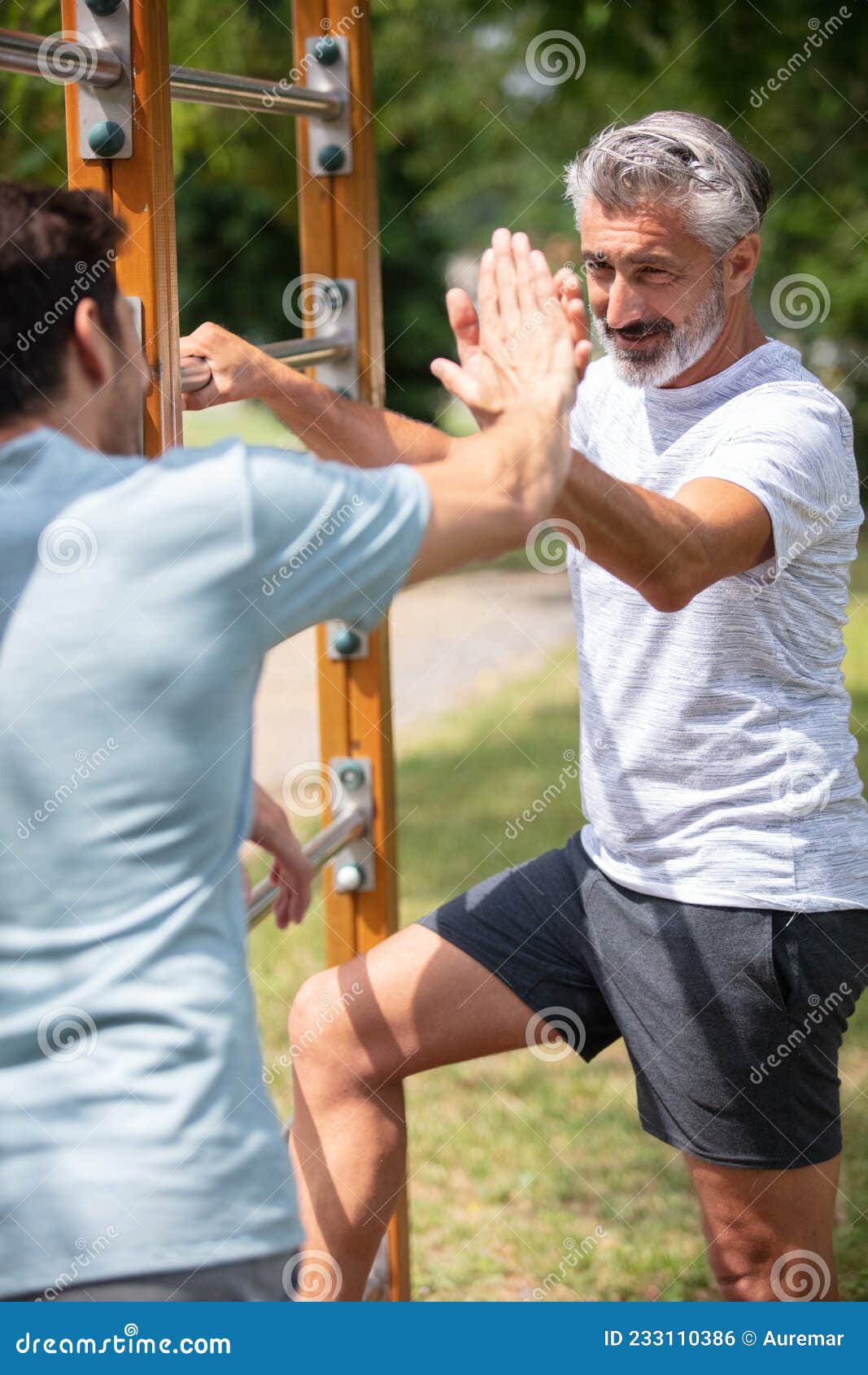 Men Exercising in Park Doing High-five Stock Photo - Image of summer ...