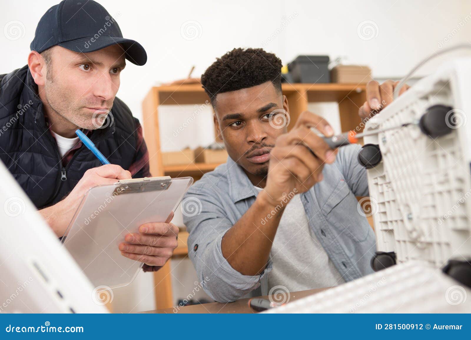 Men fixing wheels machine stock photo. Image of caster - 281500912