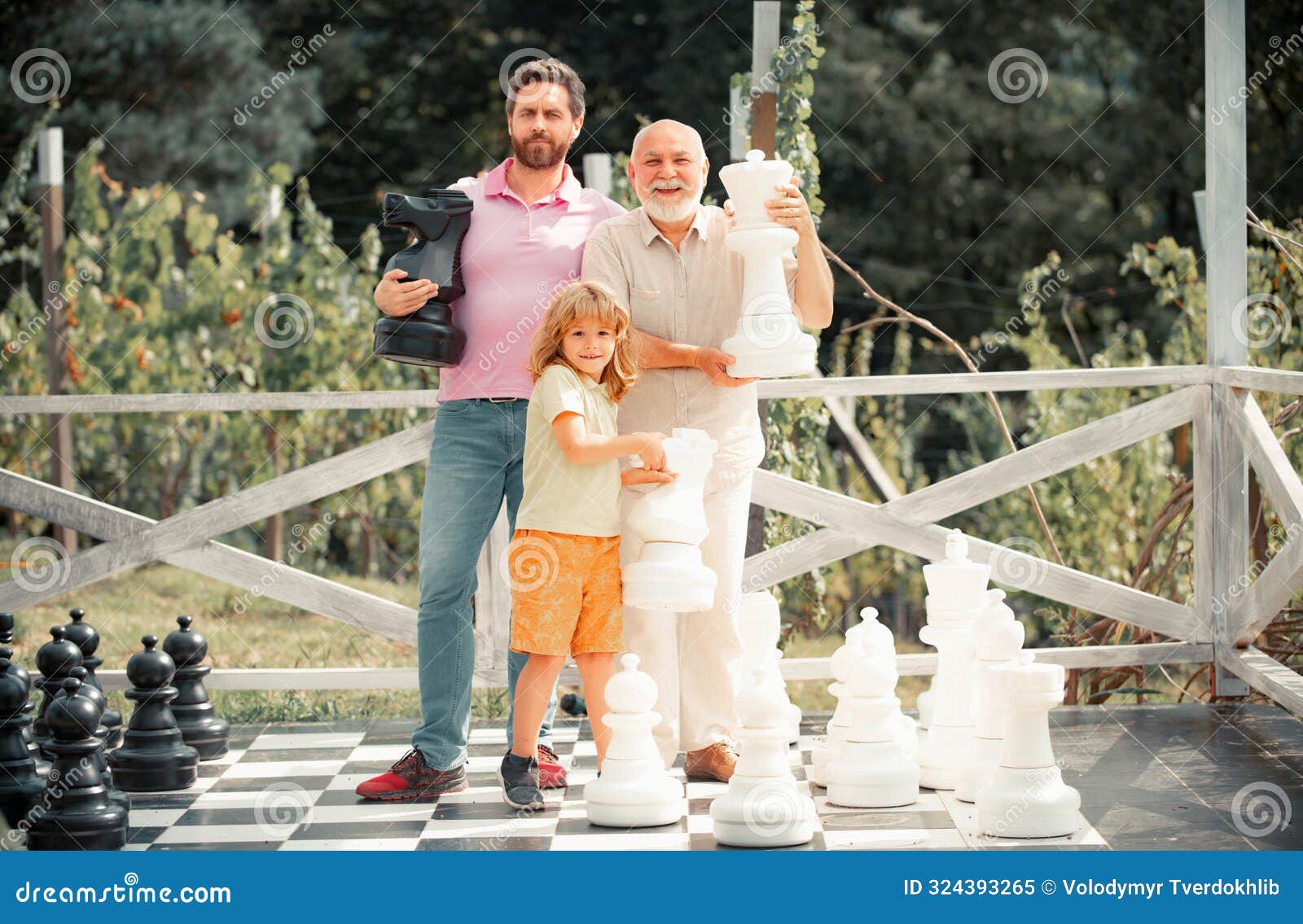 Men Generation Grandfather Father And Son Playing Chess. Developing ...