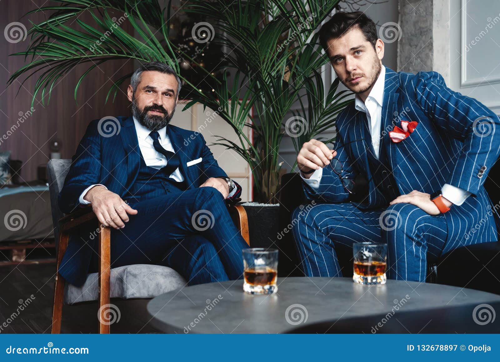 Men with a Great Style. Two Young Handsome Men in Suits Looking at ...