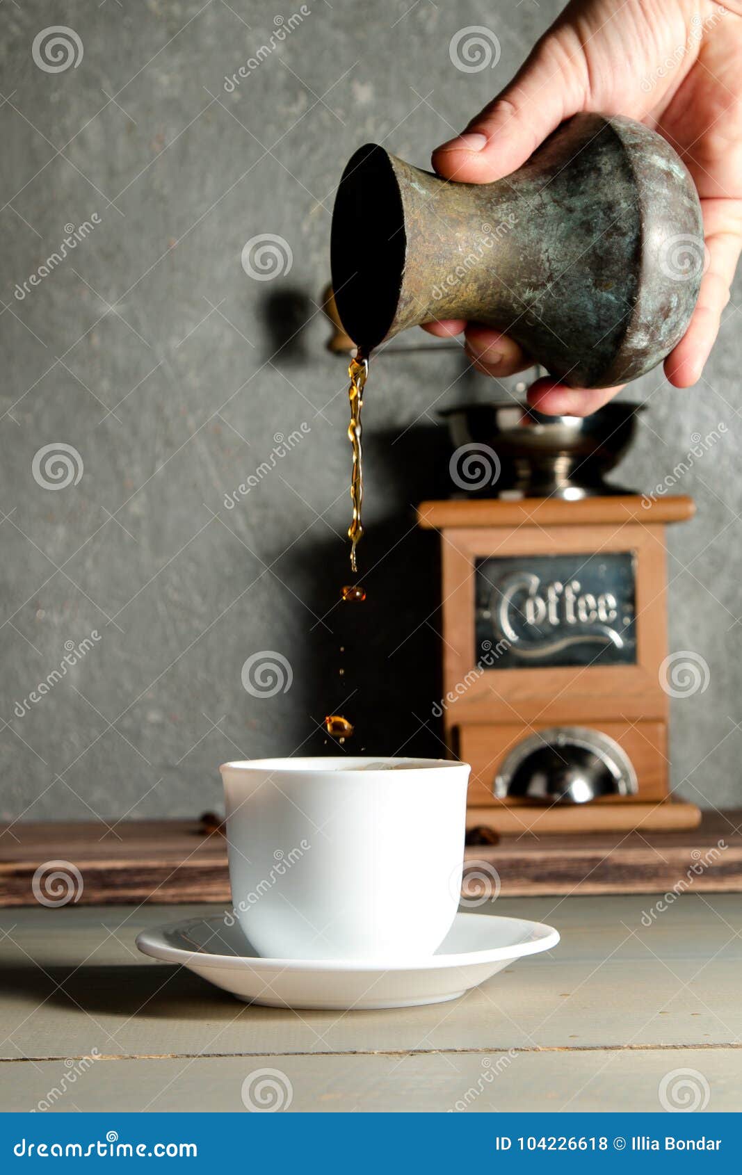 Men Hand Pouring a Cup of Coffee Creating Splash on Wooden Background ...