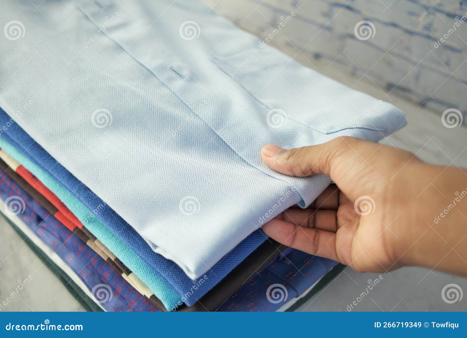 Men Hand Putting Shirts on Table Stock Image - Image of indoors ...