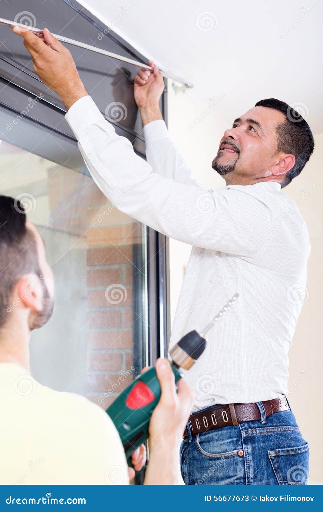 Men hang blinds stock image. Image of repair, people - 56677673