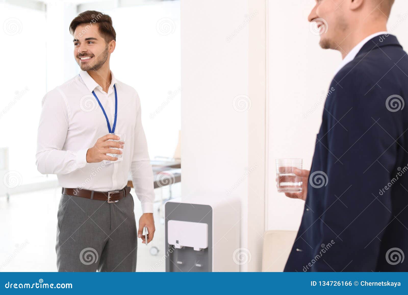 Men Having Break Near Water Cooler Stock Photo - Image of male, liquid ...