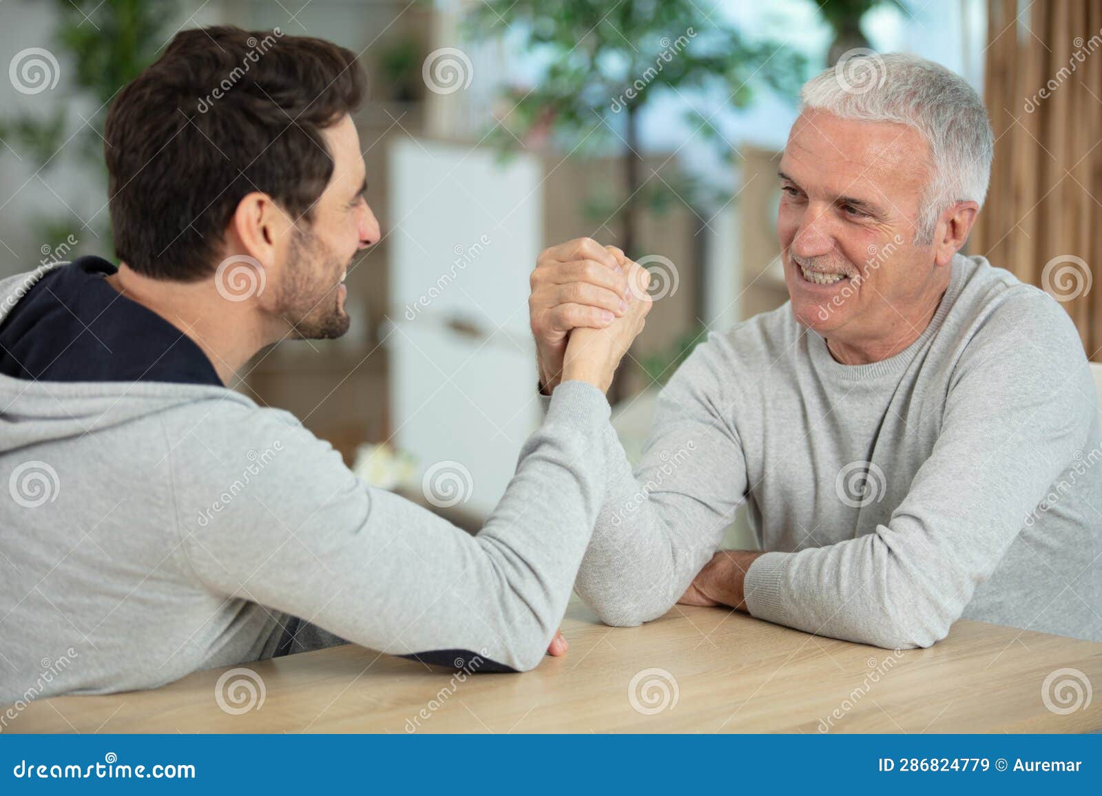 Men Having Friendly Arm Wrestle Stock Image - Image of friends, middle ...