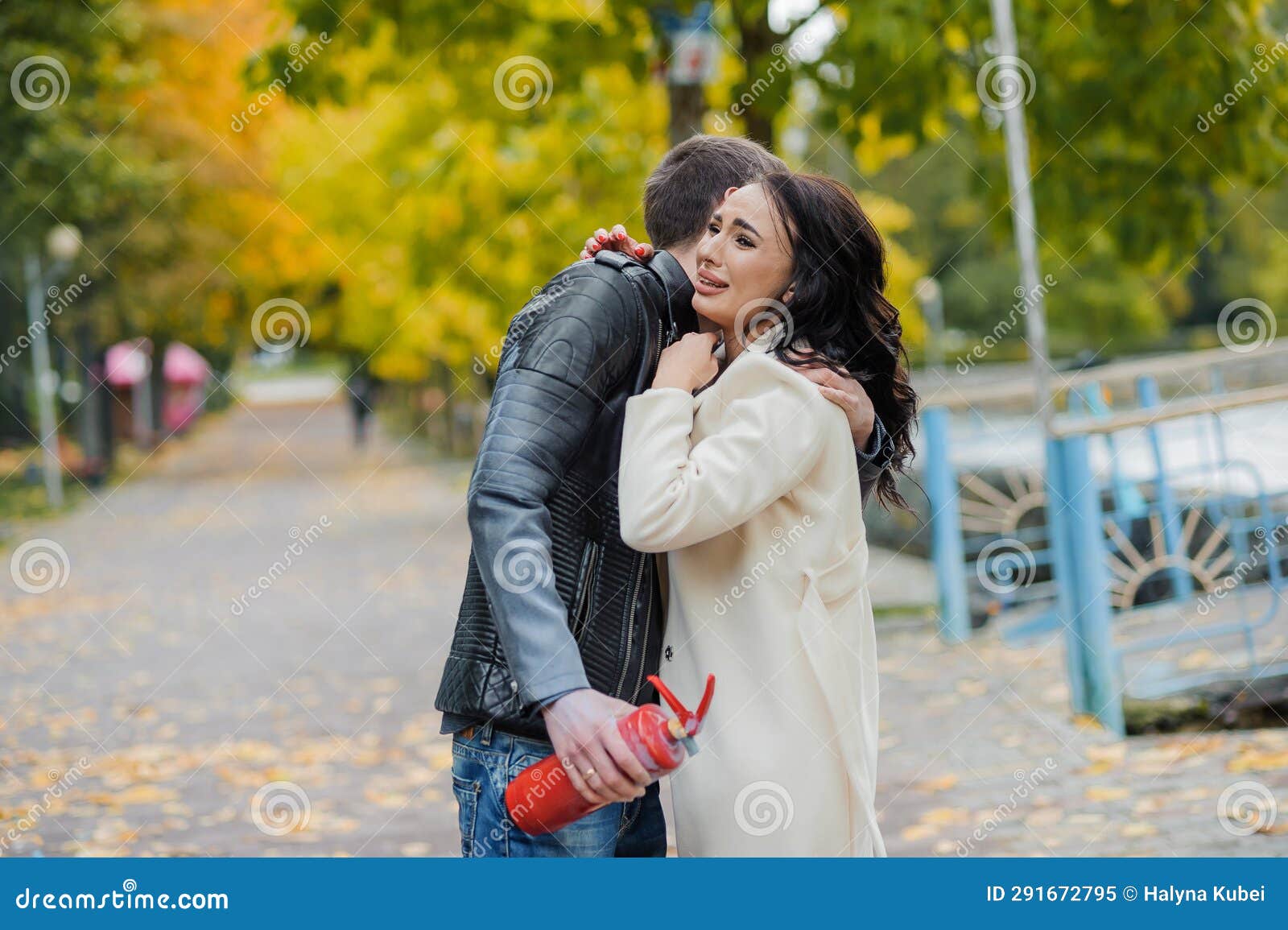 A Man Hugs A Pregnant Woman A Man Uses A Fire Extinguisher To