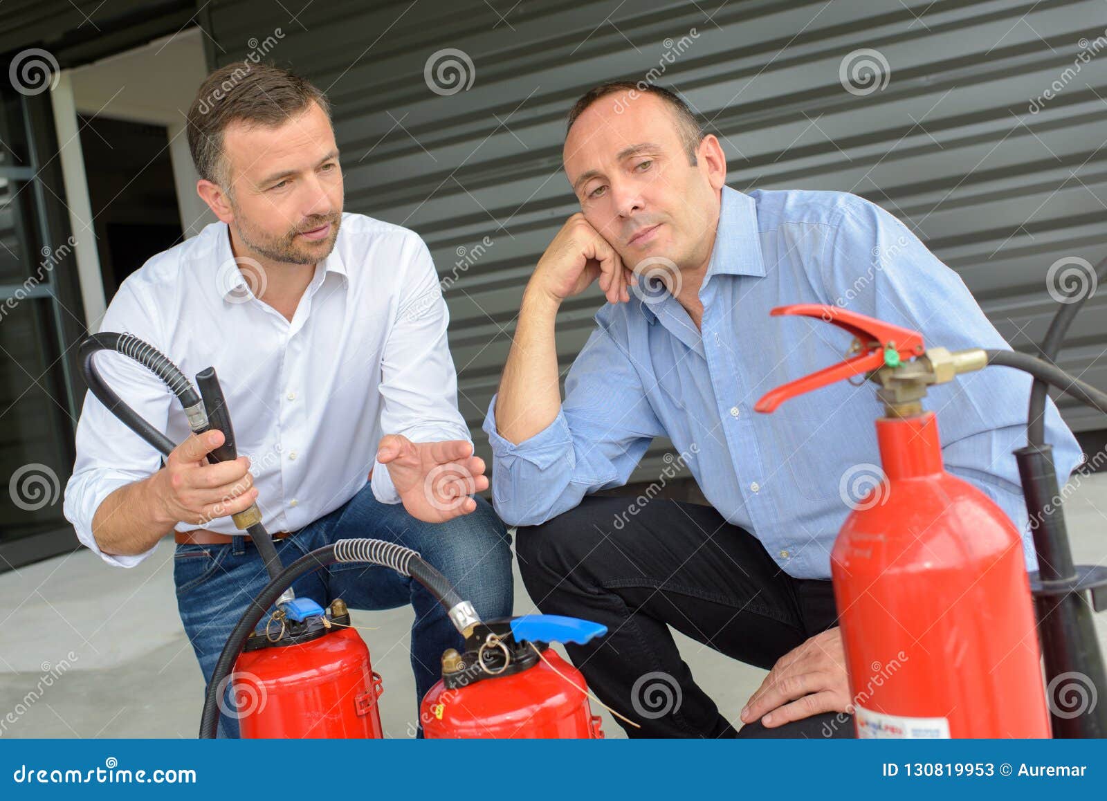 Men Looking at Fire Extinguishers Stock Image - Image of training ...
