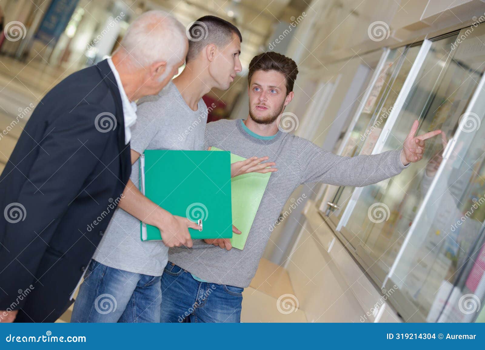 Men Looking at Poster Behind Frame Stock Photo - Image of finger ...