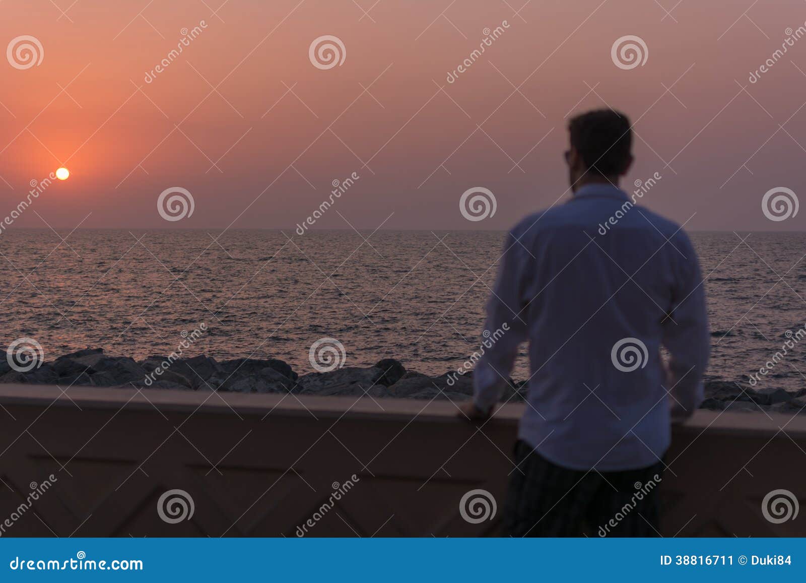 Men looking at sunset stock image. Image of person, beach - 38816711