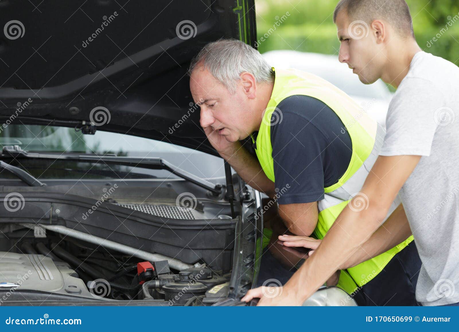Men looking under car hood stock image. Image of motor - 170650699