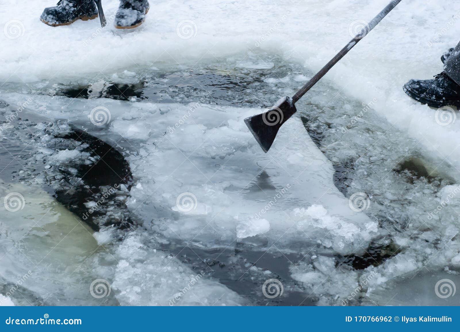 Men Making Ice-hole, Cleaning it from Ice Pieces Using Crowbar Stock ...