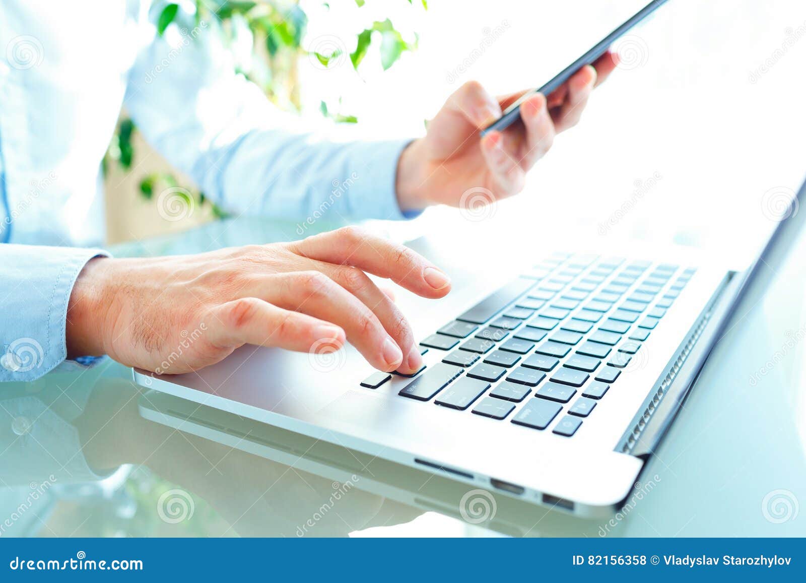 Men Office Worker Typing on the Keyboard and Using Smartphone Stock ...