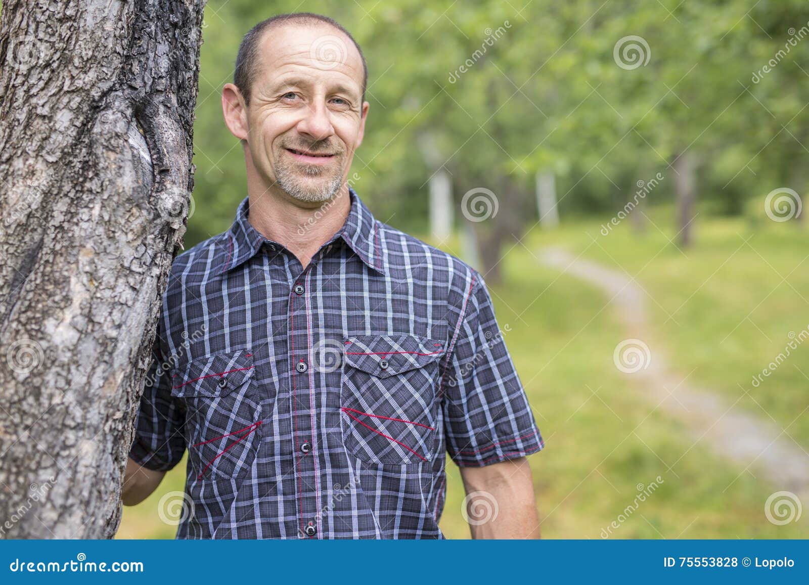 Men Outdoors Smiling Close To a Tree in the Forest Stock Photo - Image ...