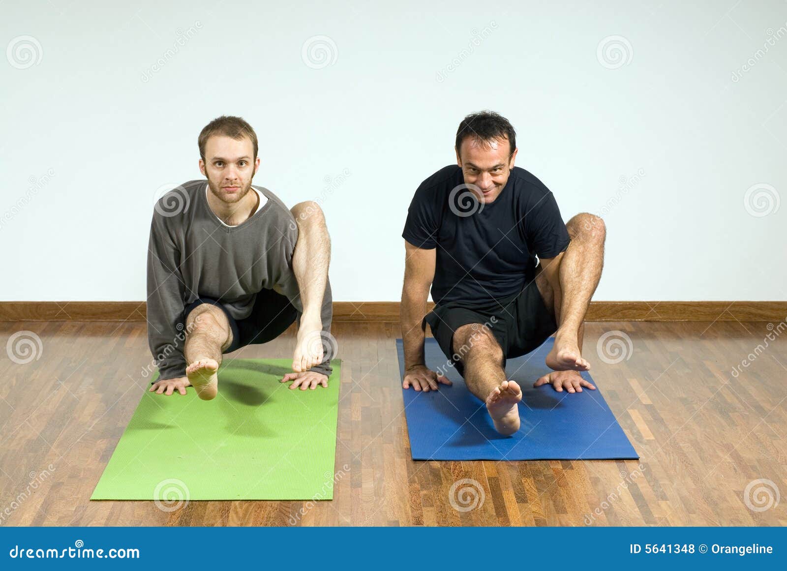 Men Performing Yoga - Horizontal Stock Photo - Image of lounging ...