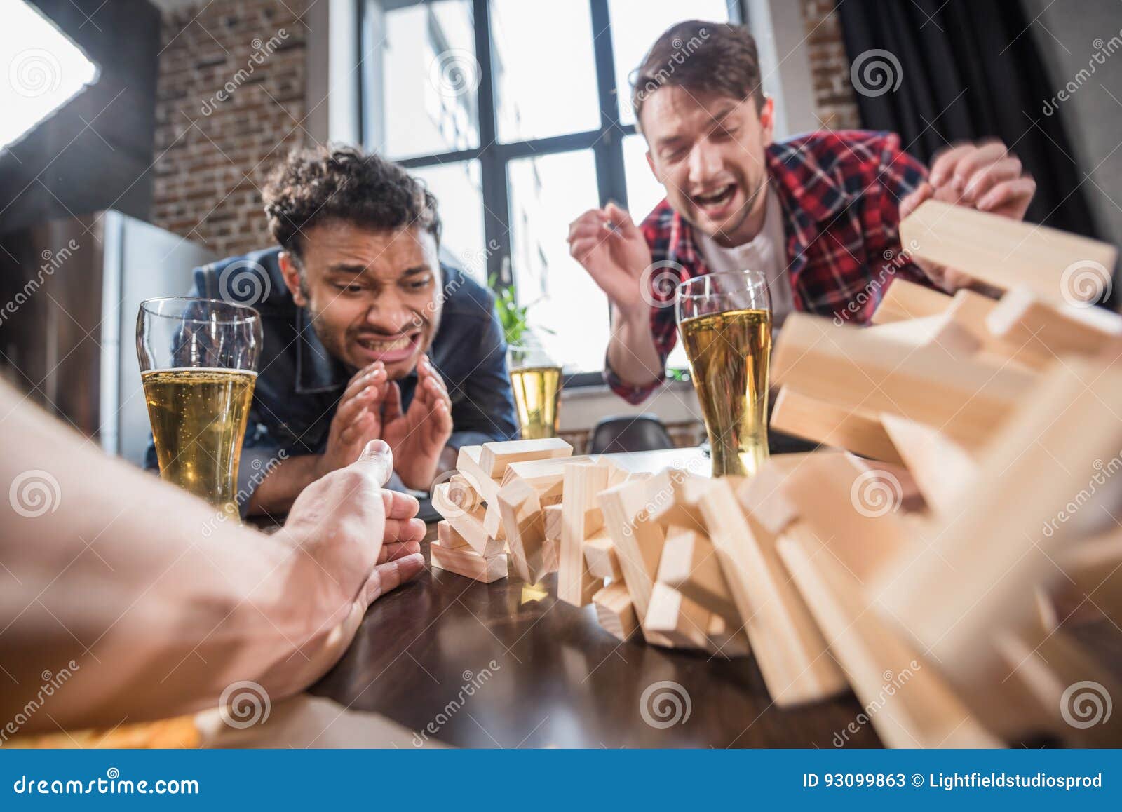 Men playing jenga game stock image. Image of playing - 93099863