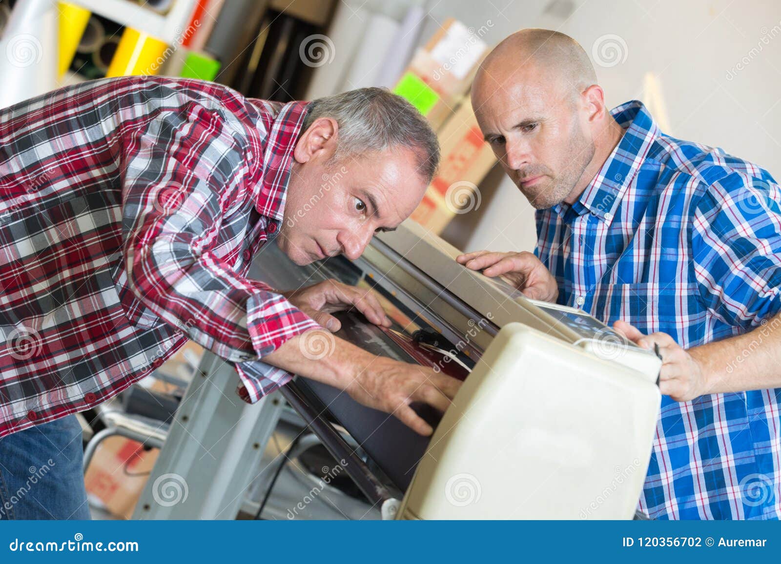 Men repairing a machine stock photo. Image of mature - 120356702