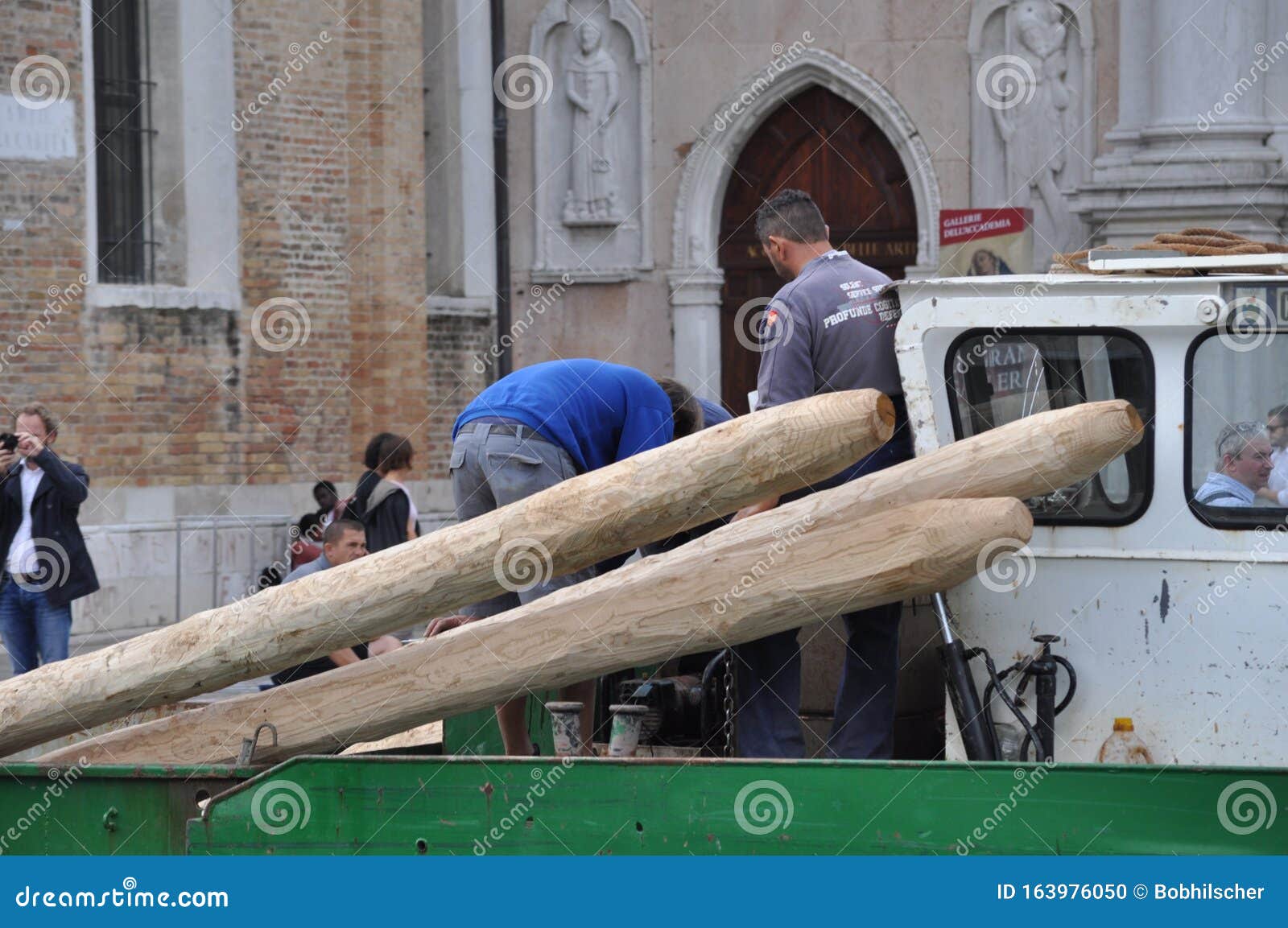 Men Replace Dock Pilings from Aboard a Work Boat on a Canal in Venice ...