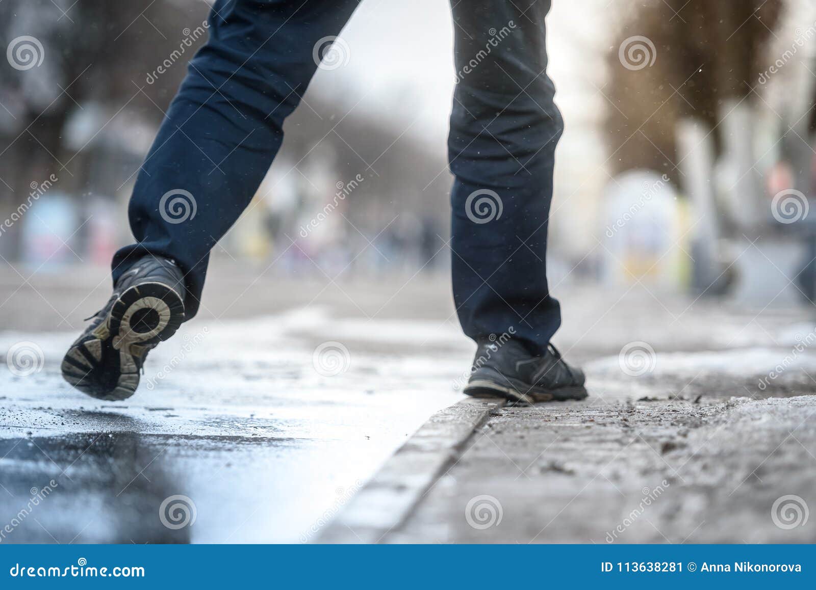 Men`s Feet Step Over a Puddle of Spring in the City Stock Image - Image ...