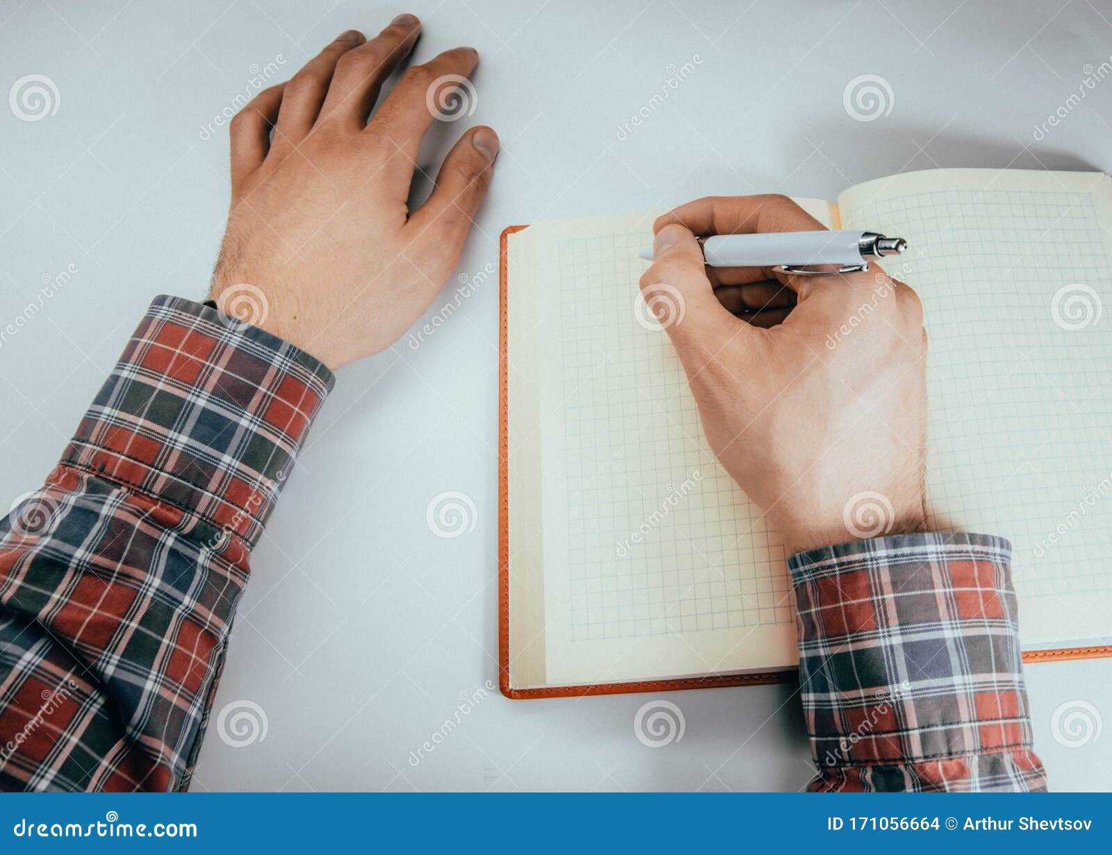 Men`s Hands, Forearm Hold a Pen, Notebook, Smartphone. Hands Write in ...