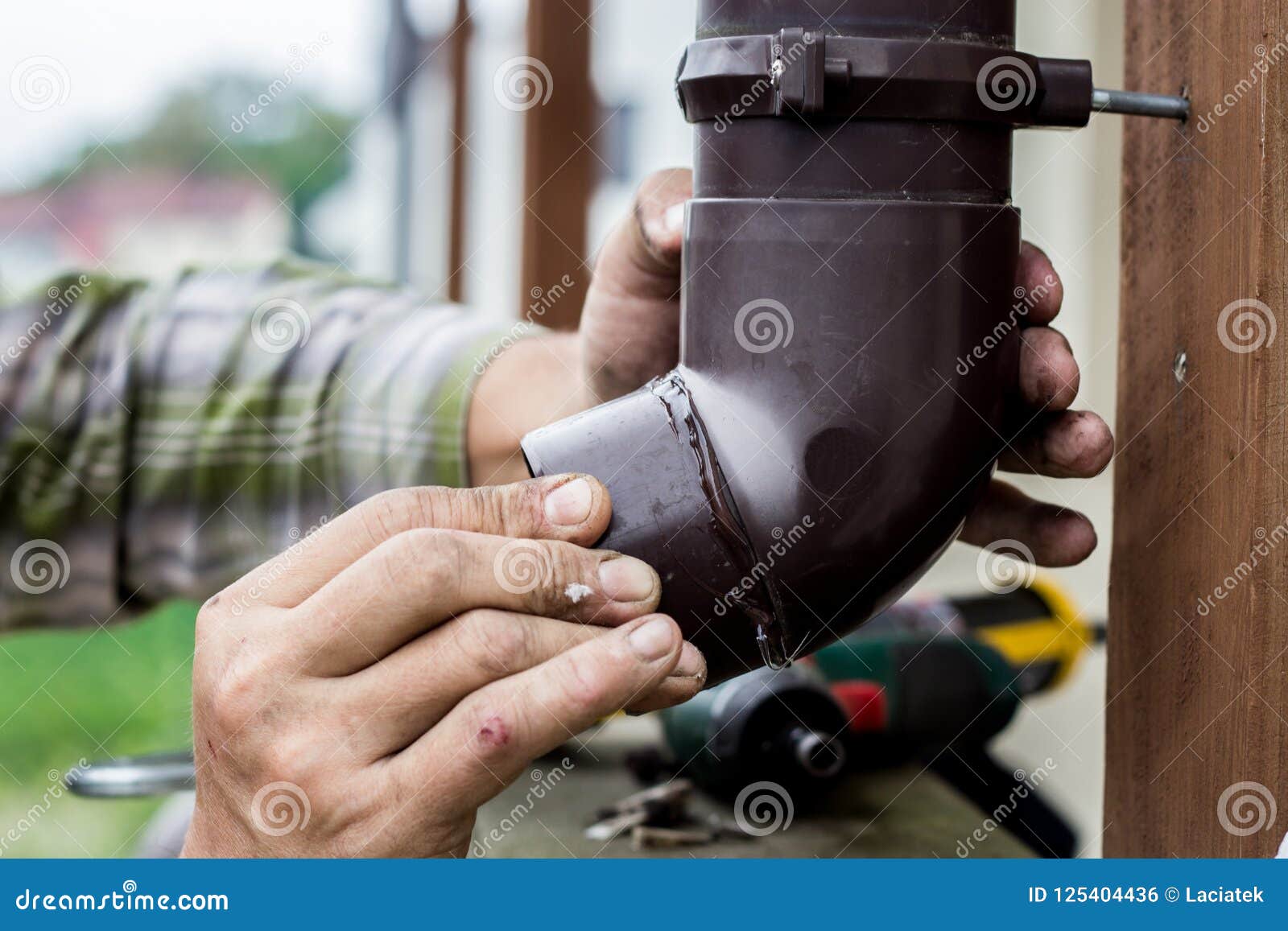 Men`s Hands Seal the Gutter on the Outside Stock Photo - Image of ...