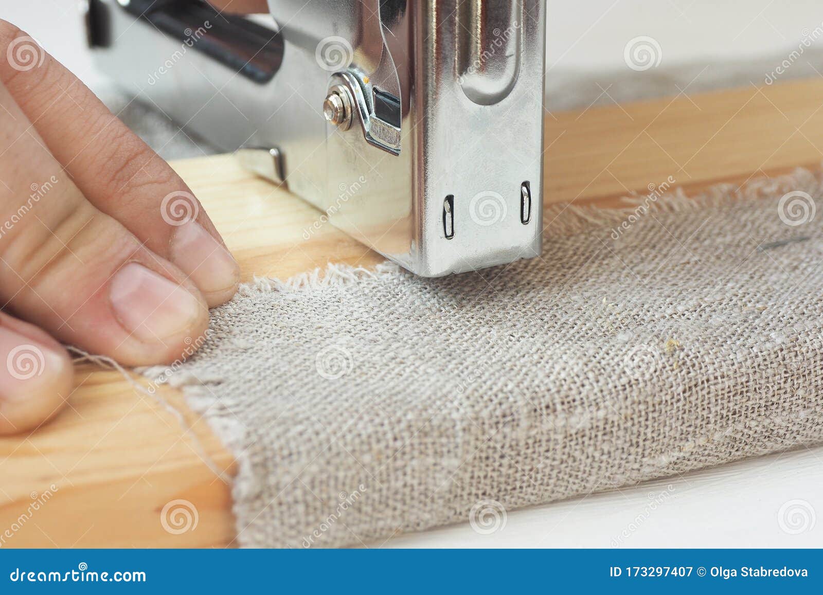 Men`s Hands are Wrapped in Rough Board with a Construction Stapler ...