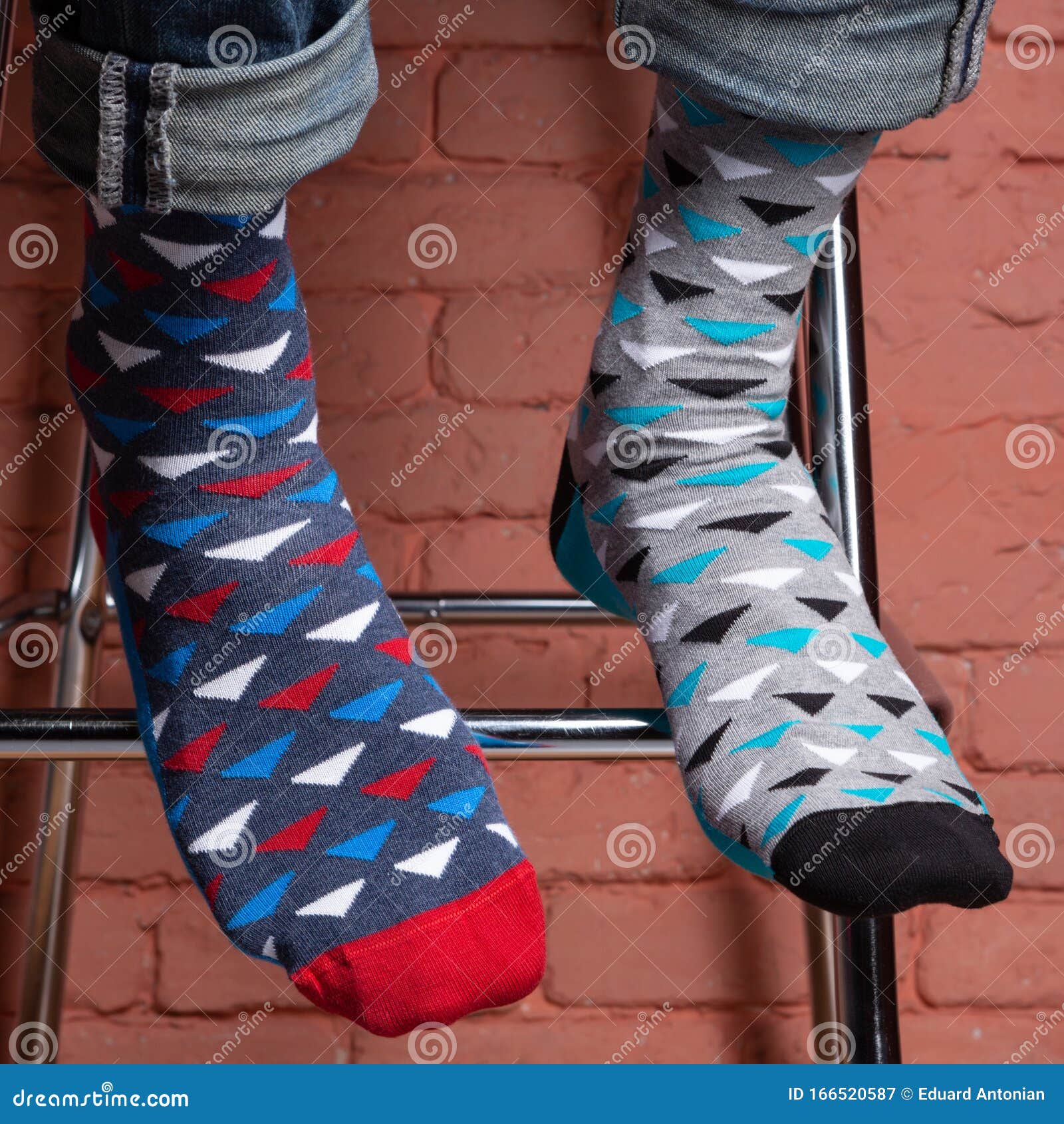 On Men`s Legs Different Colored Socks, on a Background of a Brick Wall ...
