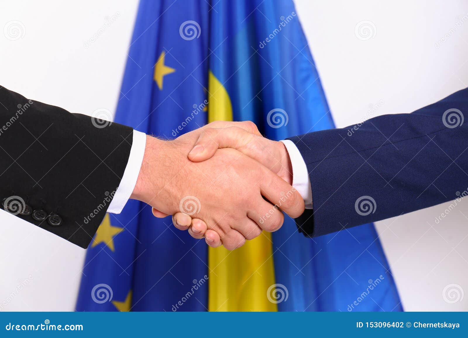 Men Shaking Hands Against Flags. International Relationships Stock ...