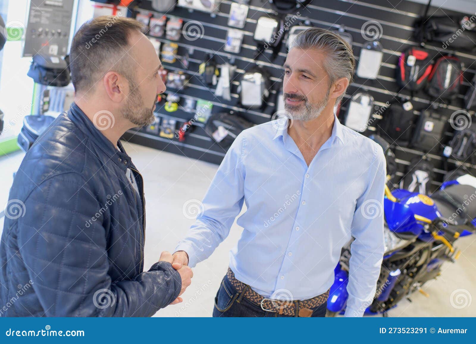 Men Shaking Hands in Motorbike Store Stock Image - Image of vendor ...