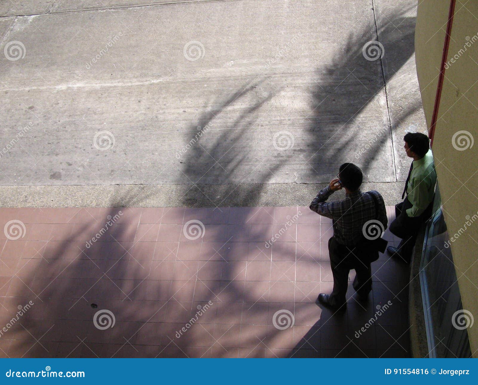 Men Standing on Street and Talking on Mobile Phone, Aerial View ...