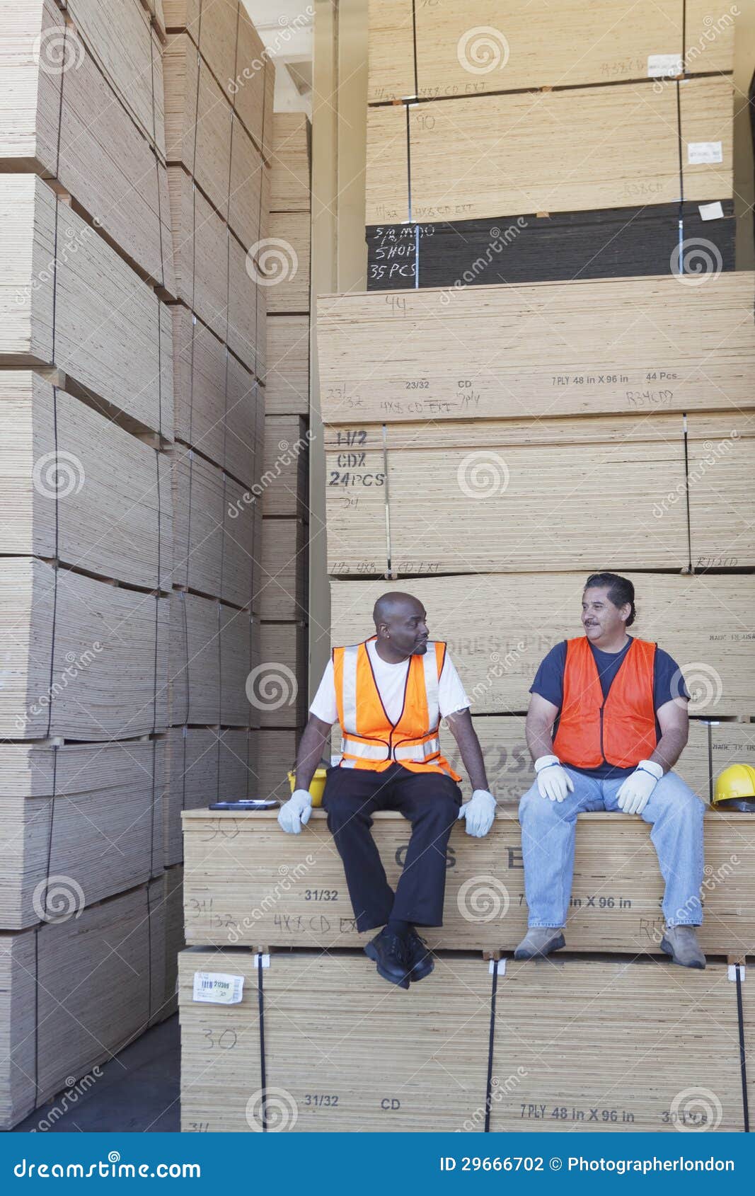 Men Taking Break from Work in Warehouse Stock Photo - Image of sitting ...