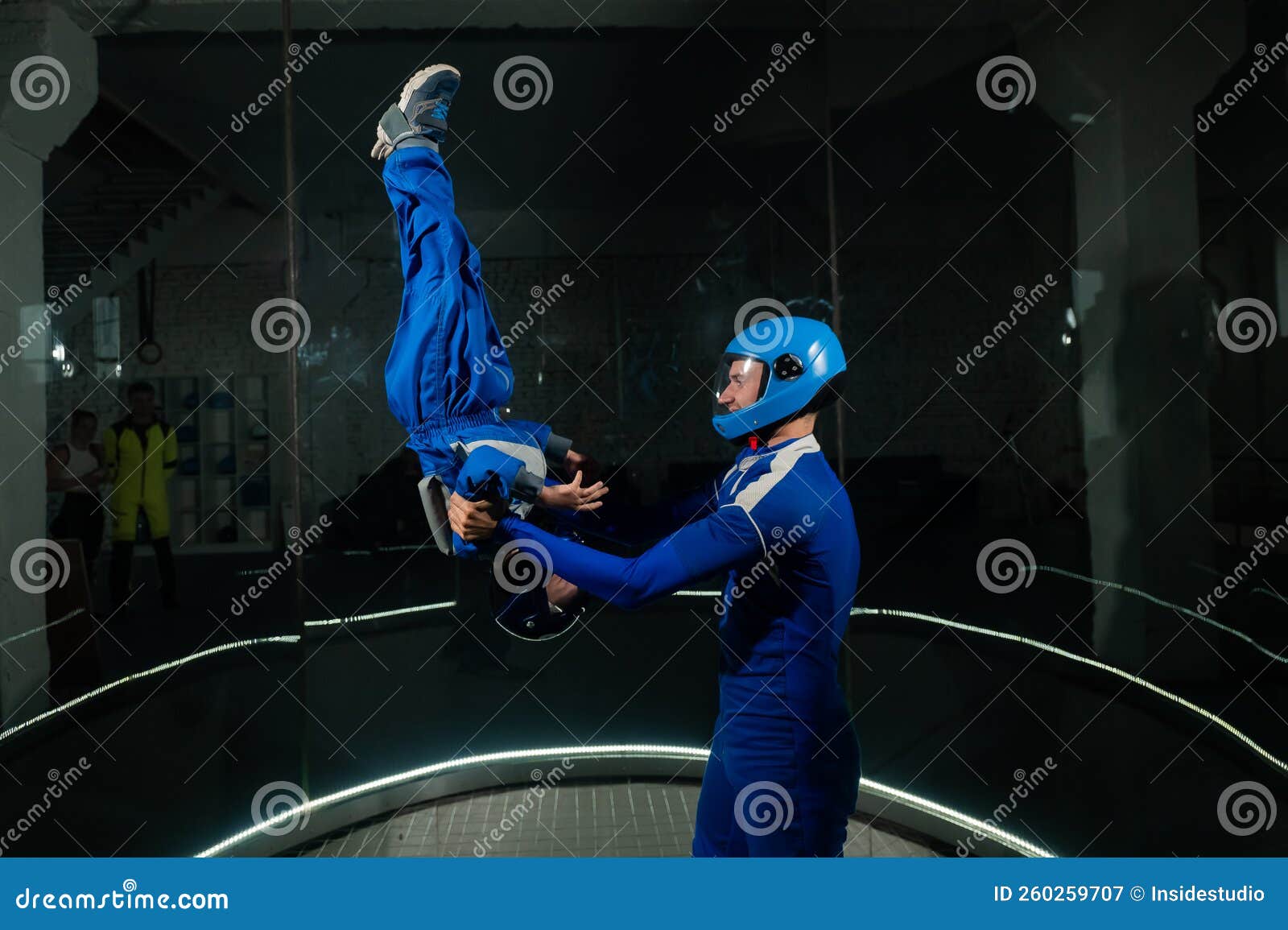 A Man Teaches a Boy To Fly in a Wind Tunnel. Lack of Gravity. Stock ...