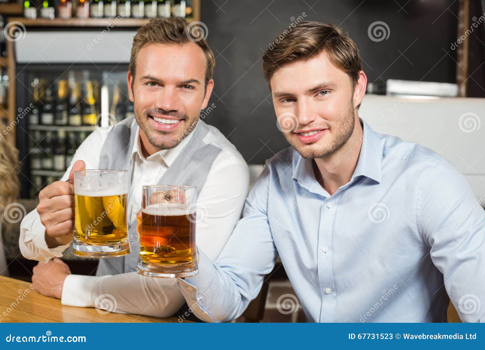 Men toasting with beers stock image. Image of caucasian - 67731523