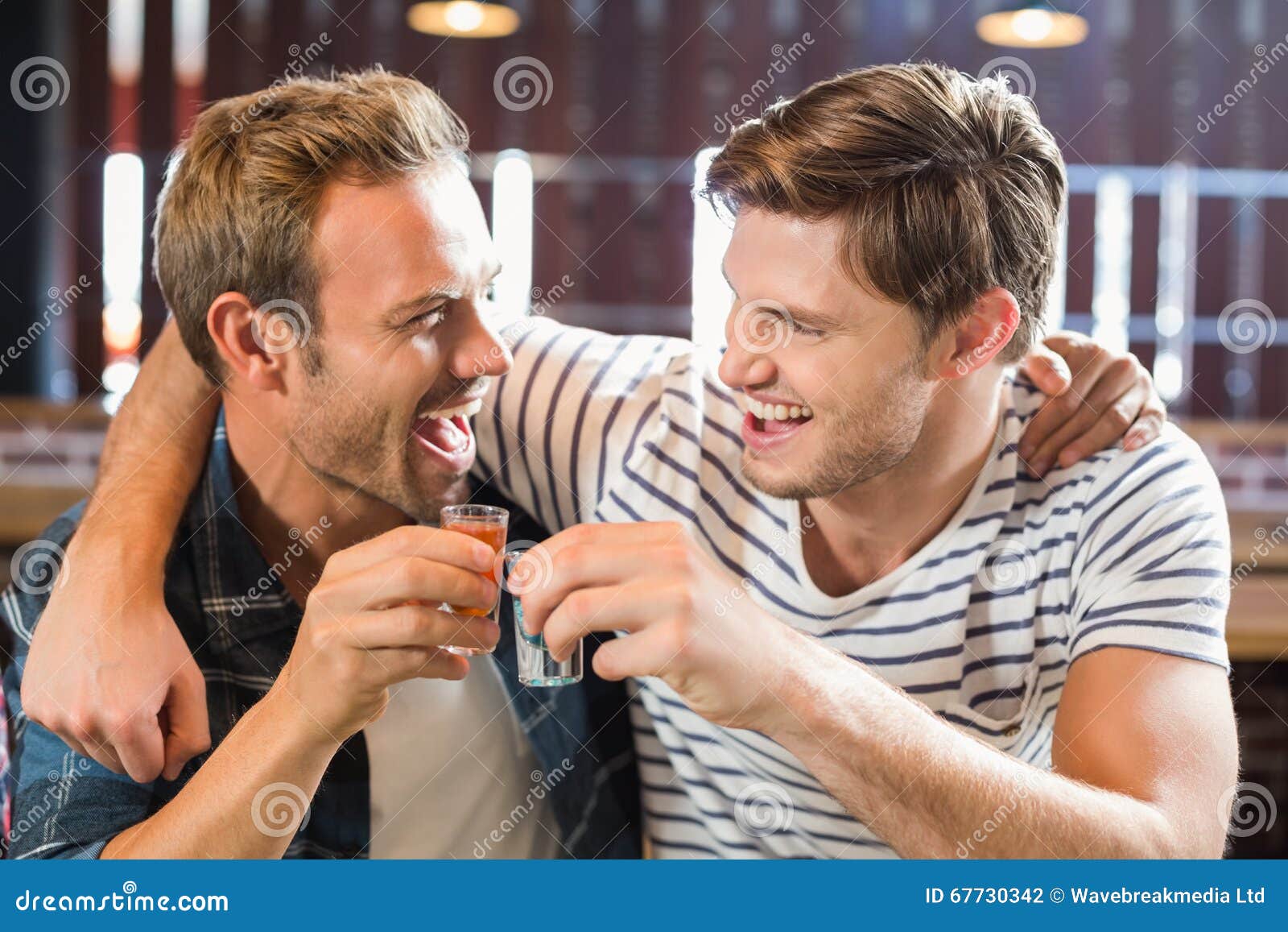 Men toasting with shots stock photo. Image of amusing - 67730342