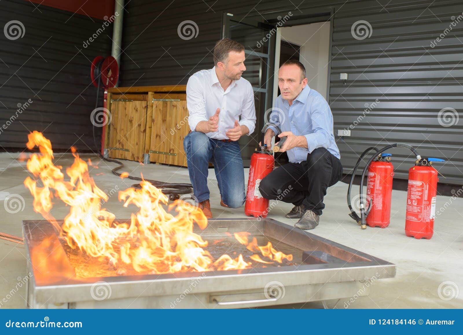 Men Training with Fire Extinguishers Stock Photo - Image of firefighter ...