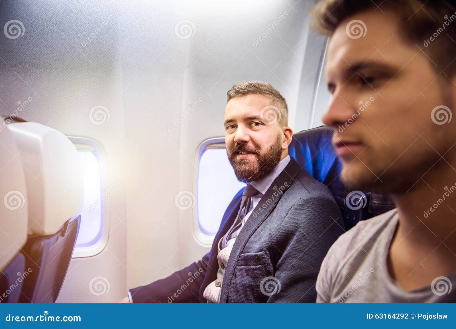 Men travelling by airplane stock photo. Image of beard - 63164292