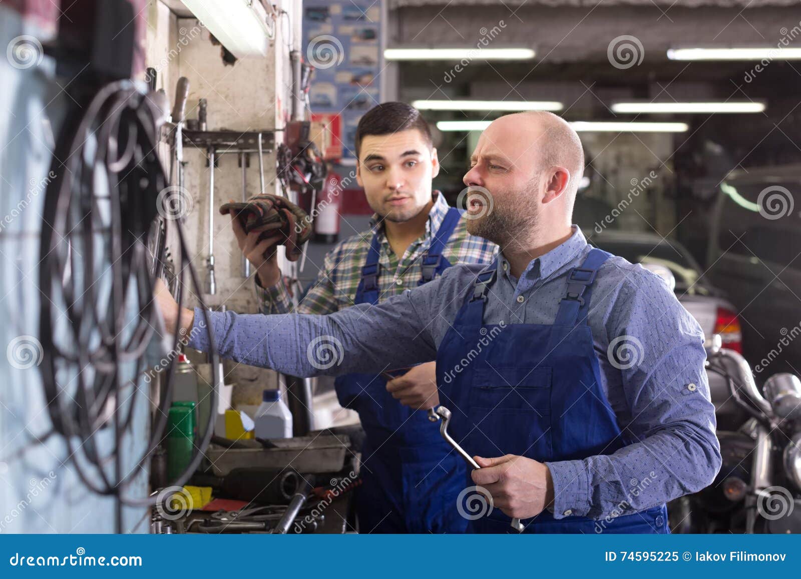 Men working at carshop stock image. Image of people, artificer - 74595225