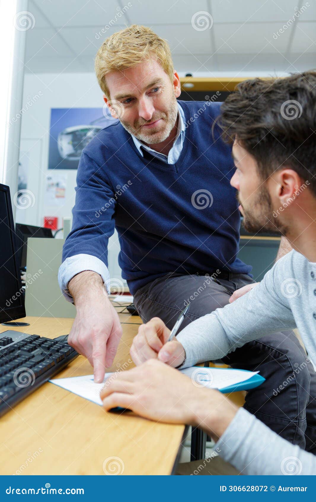 Men Working at Computer with Paperwork in Office Stock Photo - Image of ...