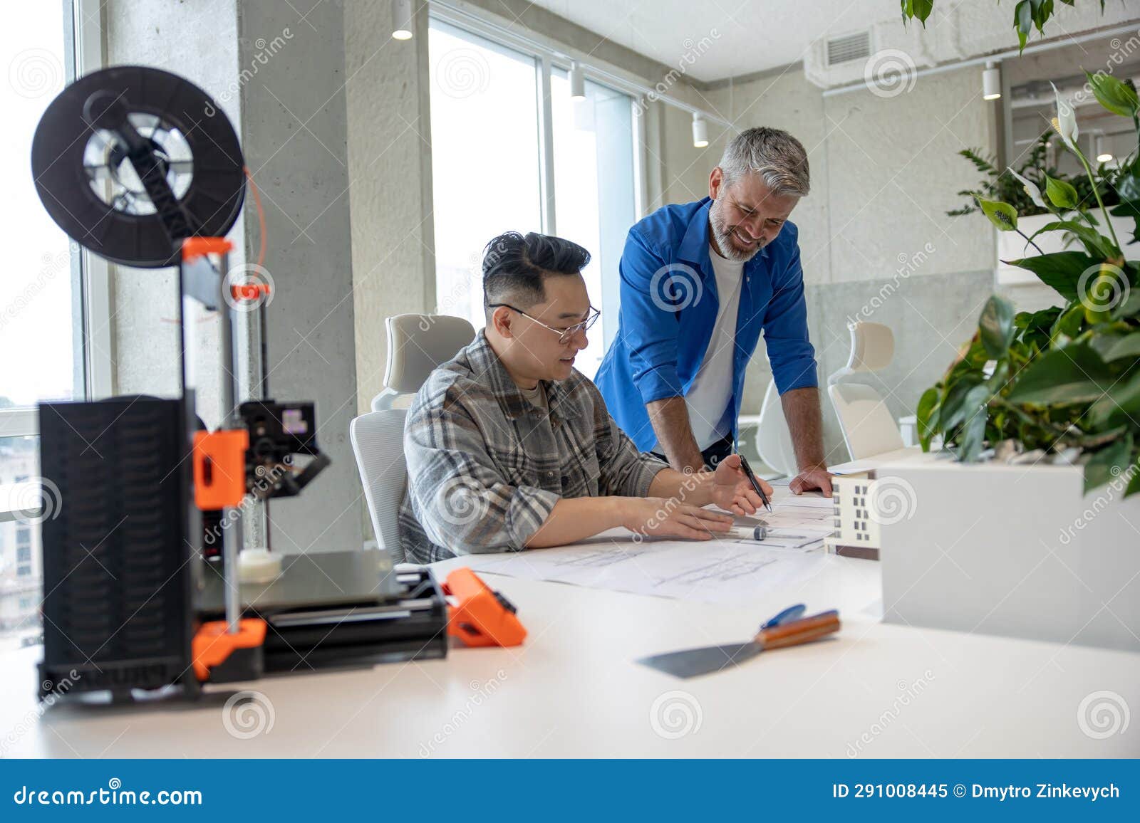Men Working with 3D Printer and Blueprint for Designing Mechanical Parts in High Tech Workshop ...