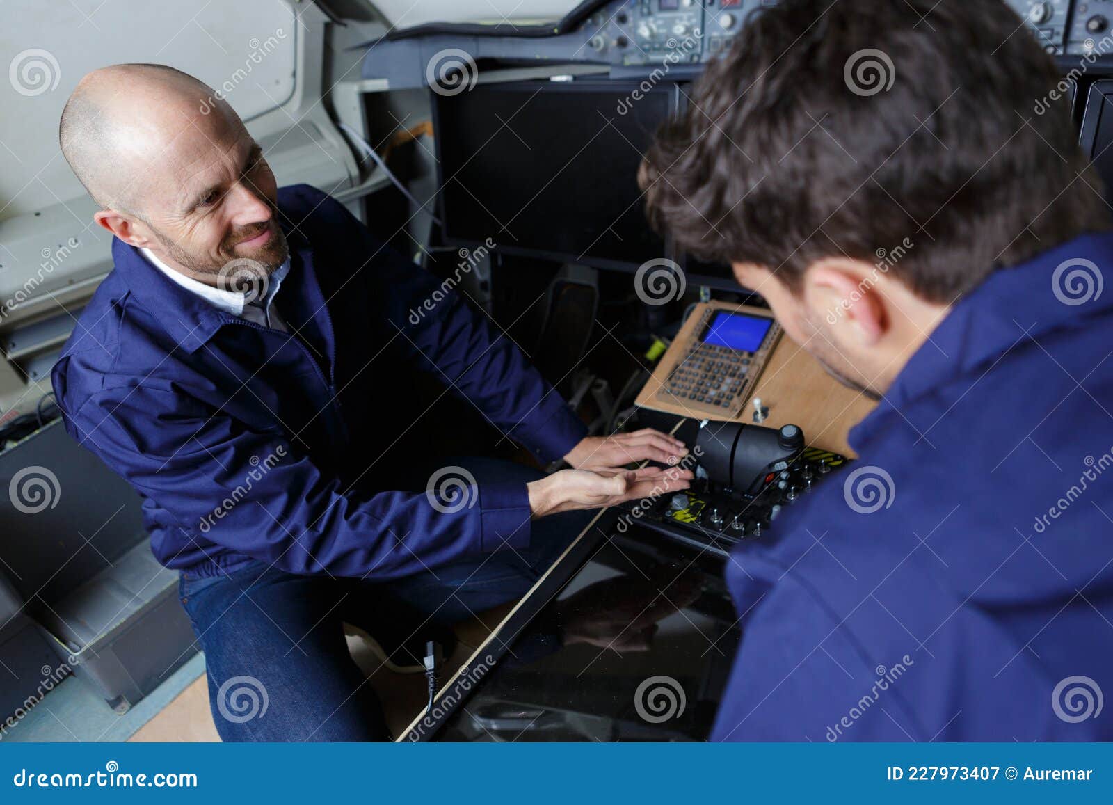 Men Working on Remote Control in Cockpit Factory Stock Image - Image of ...